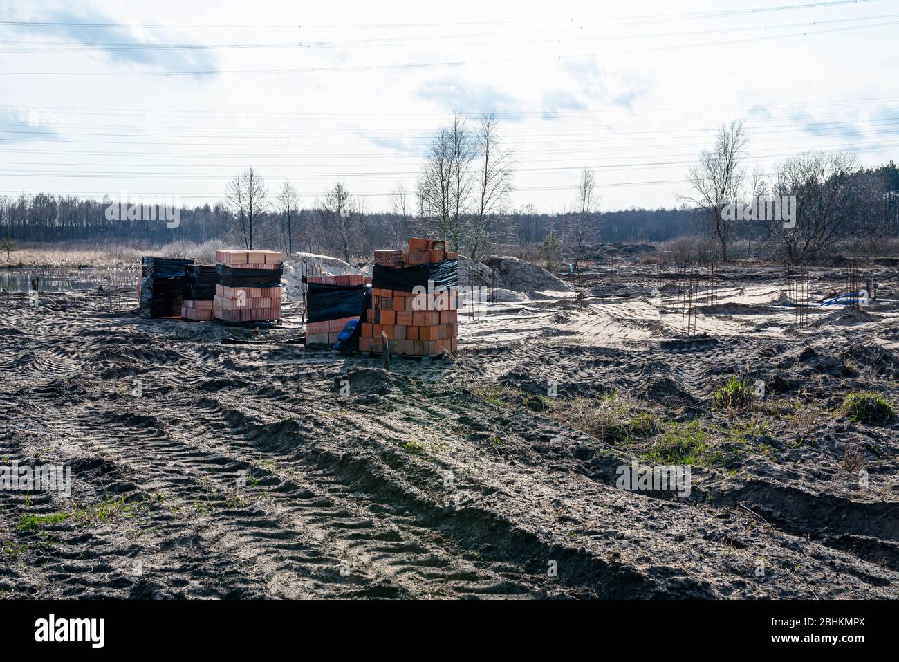 Reinforcing rods protruding from the ground in a place where there will ...