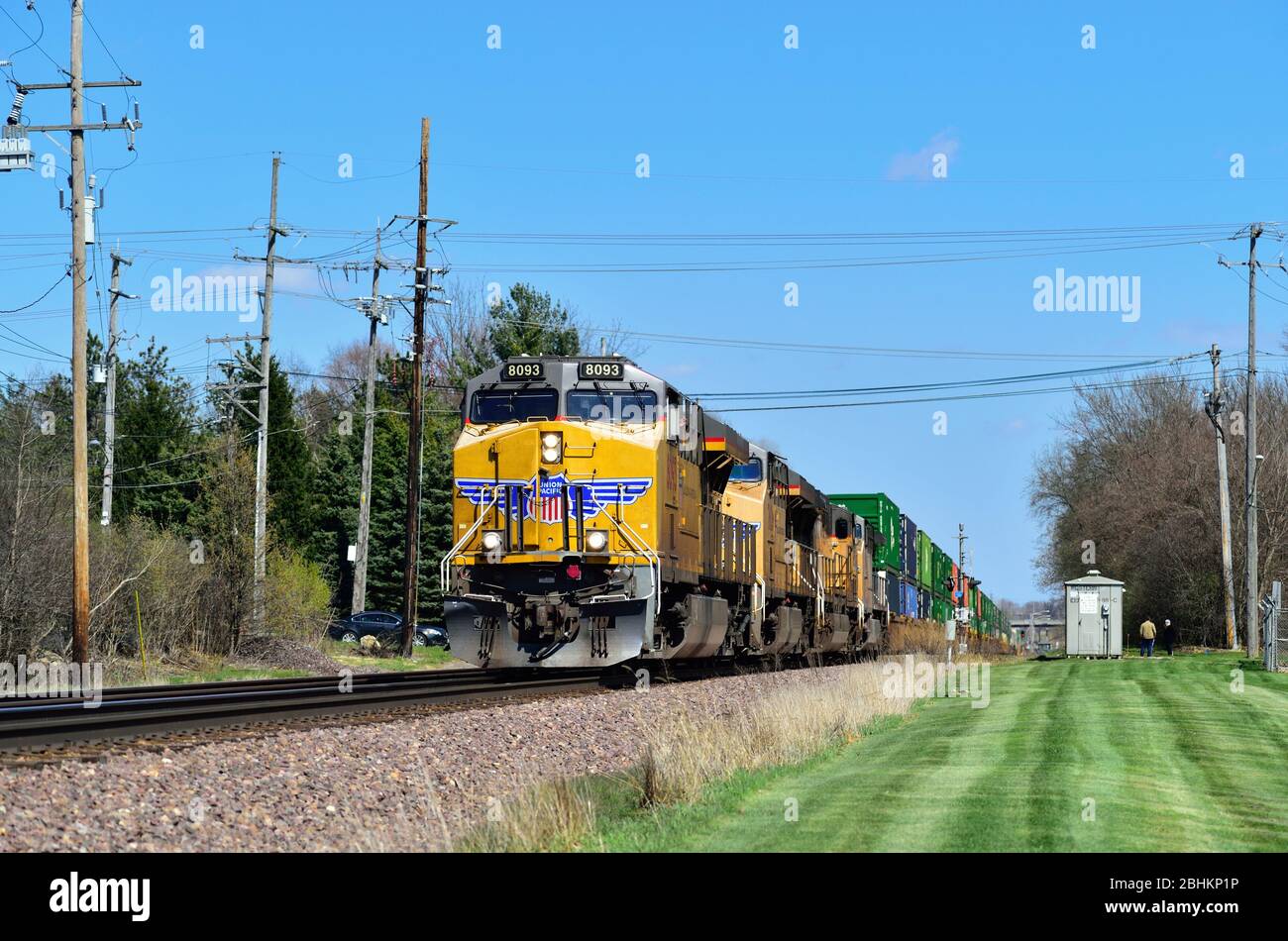 Geneva, Illinois, USA. Four locomotives lead a freight train of stack ...