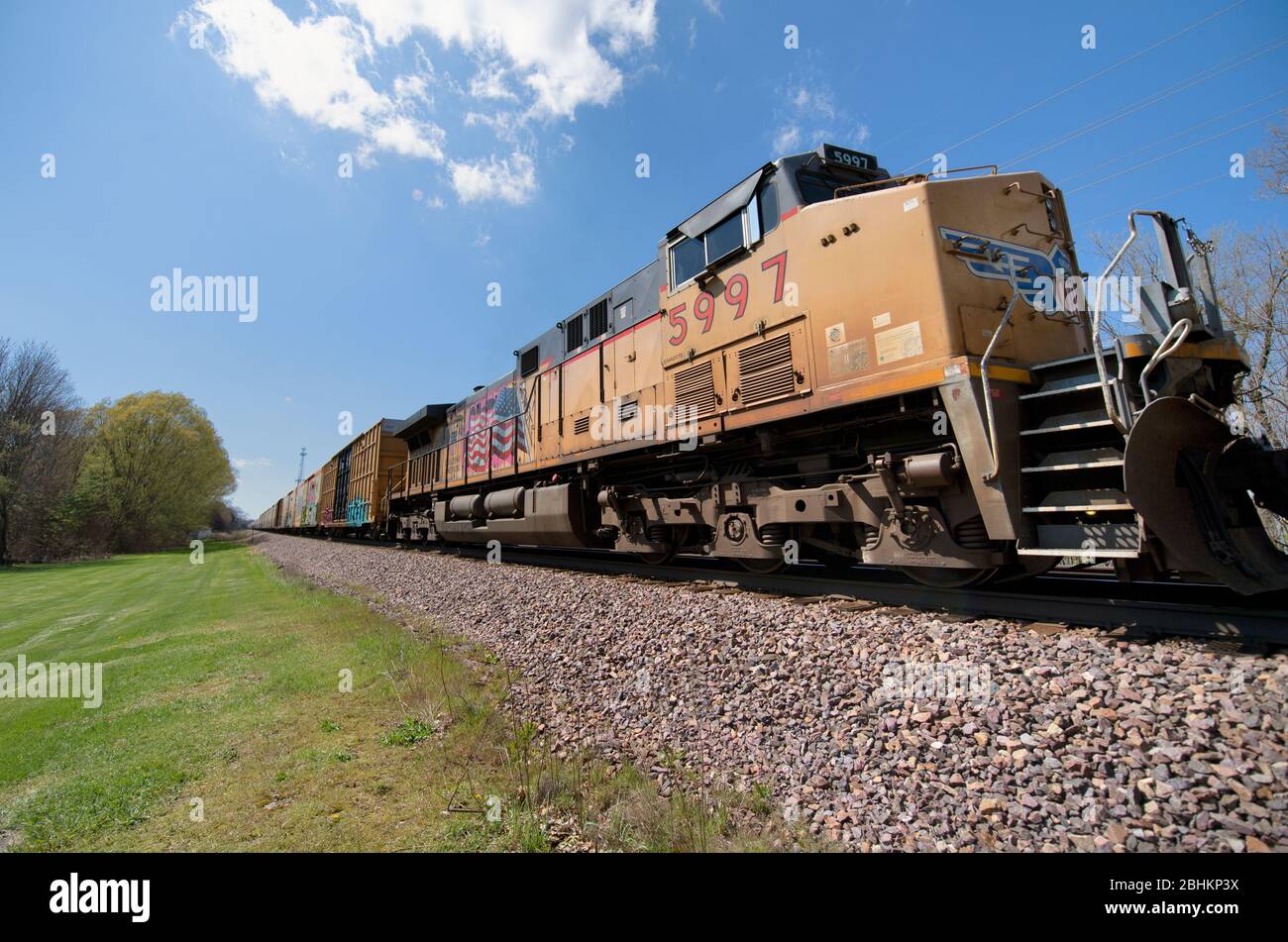 Geneva, Illinois, USA. A helper locomotive cut in mid train helps to ...