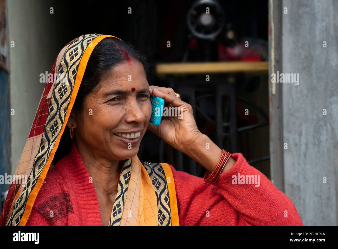 Indian woman talking on a mobile phone and smiling Stock Photo - Alamy