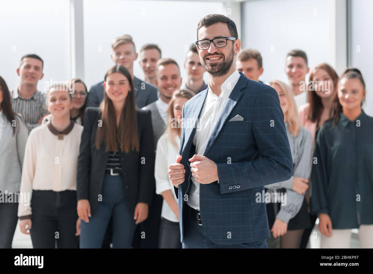 Manager and a group of diverse employees standing in the new office ...