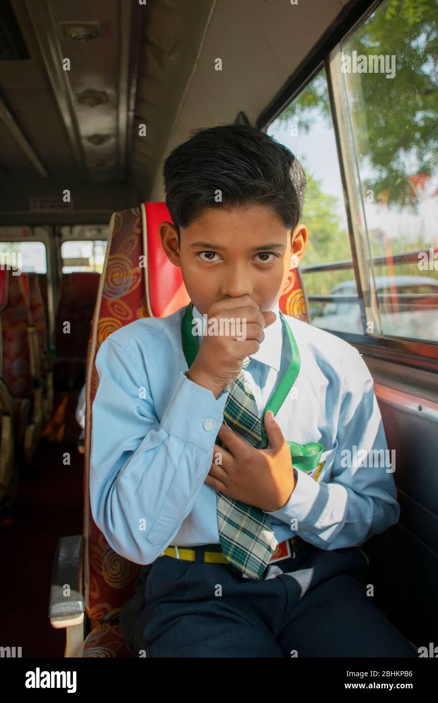 boy coughing in school bus Stock Photo - Alamy