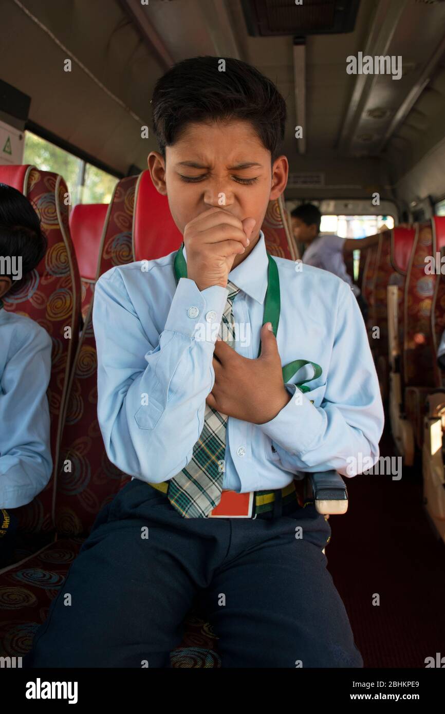 boy coughing in school bus Stock Photo - Alamy