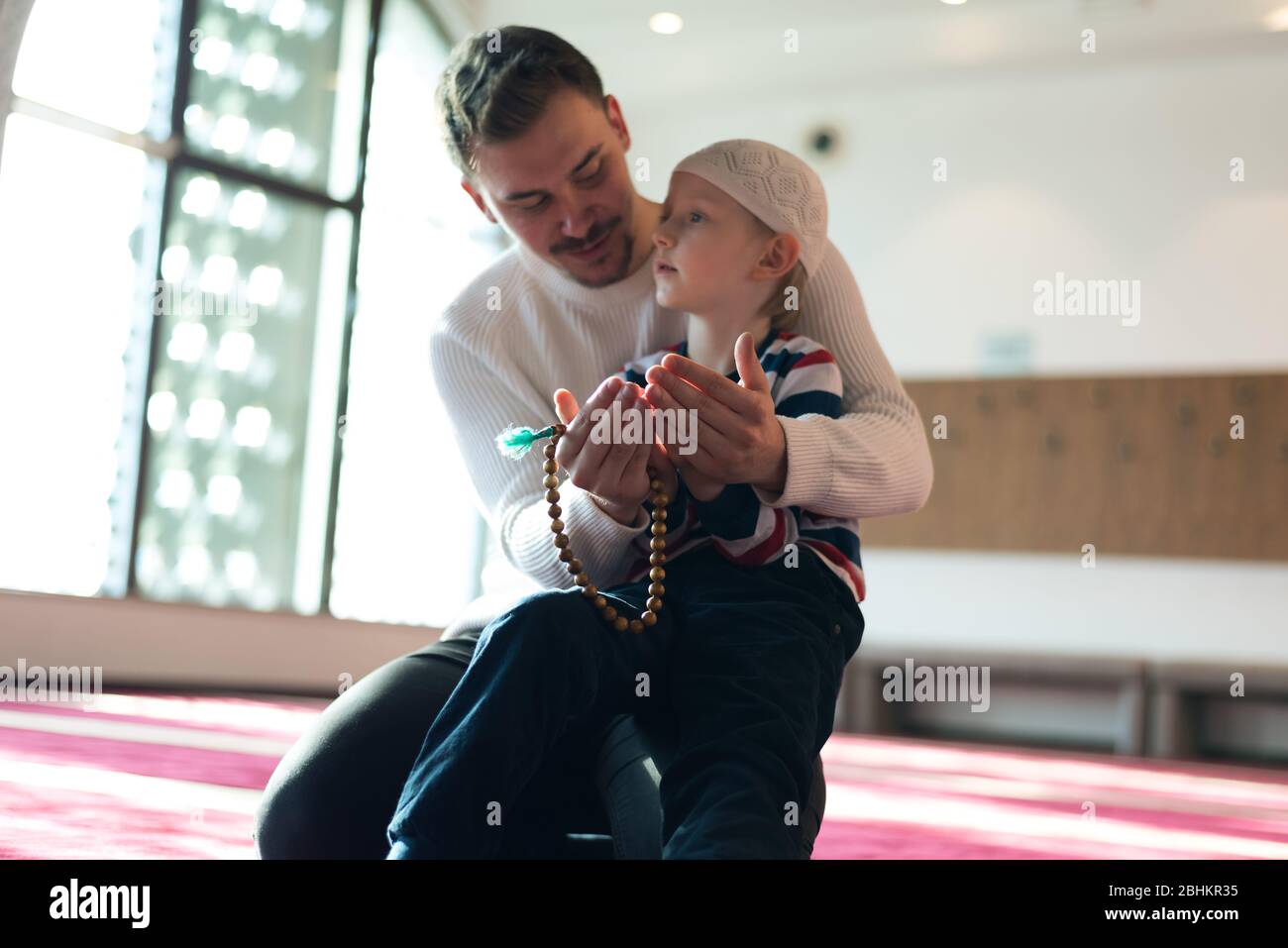 Muslim father and son praying together. Muslim dad and son praying in ...