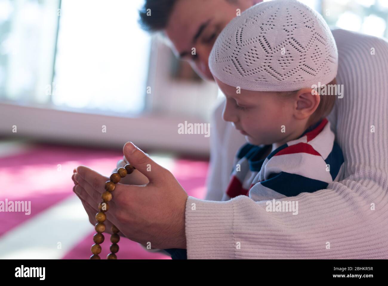 Muslim father and son praying together. Muslim dad and son praying in ...