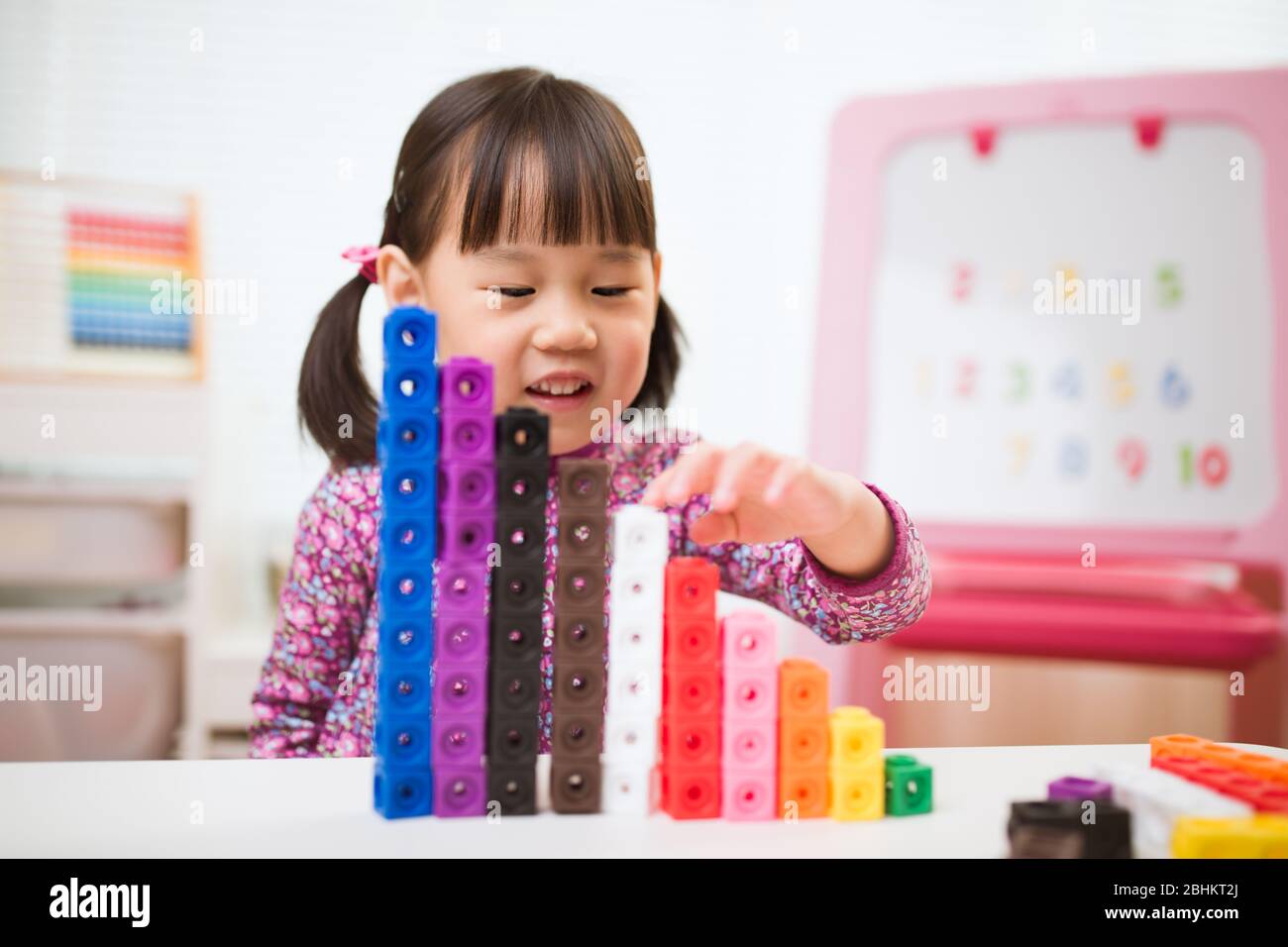 toddler girl play number blocks for homeschooling Stock Photo - Alamy