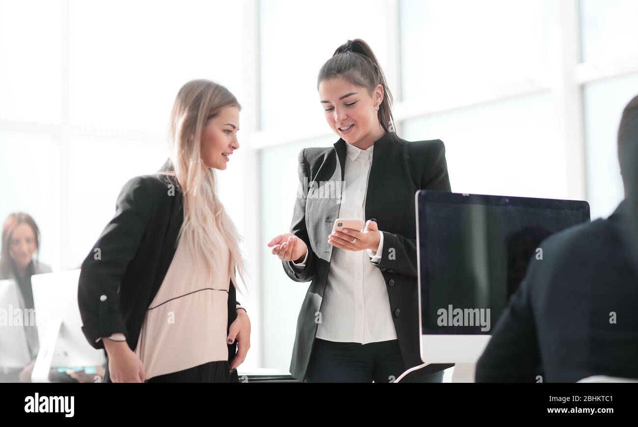two young employees reading a message on their smartphone Stock Photo ...