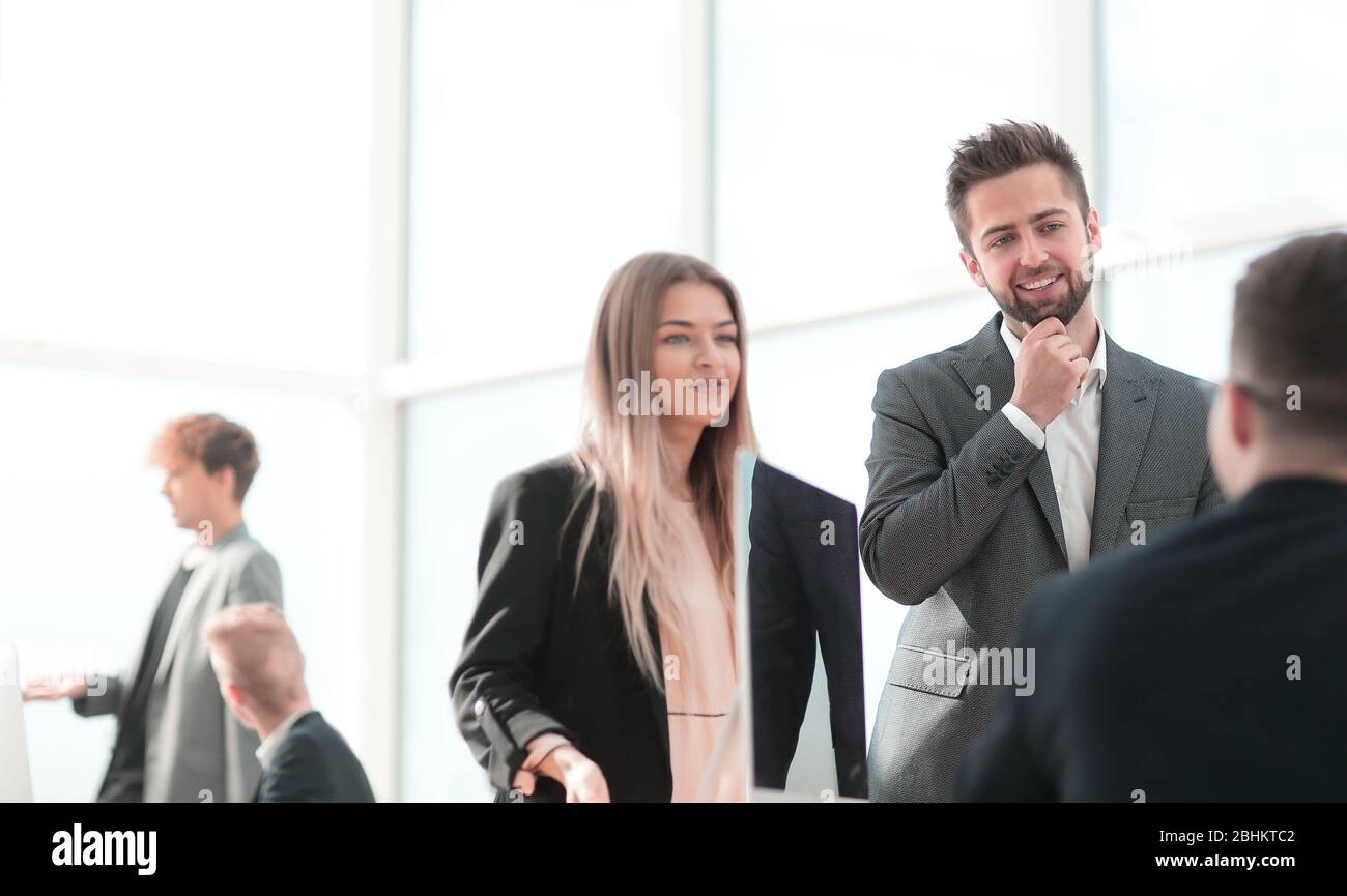 group of employees discussing something standing in the office Stock ...