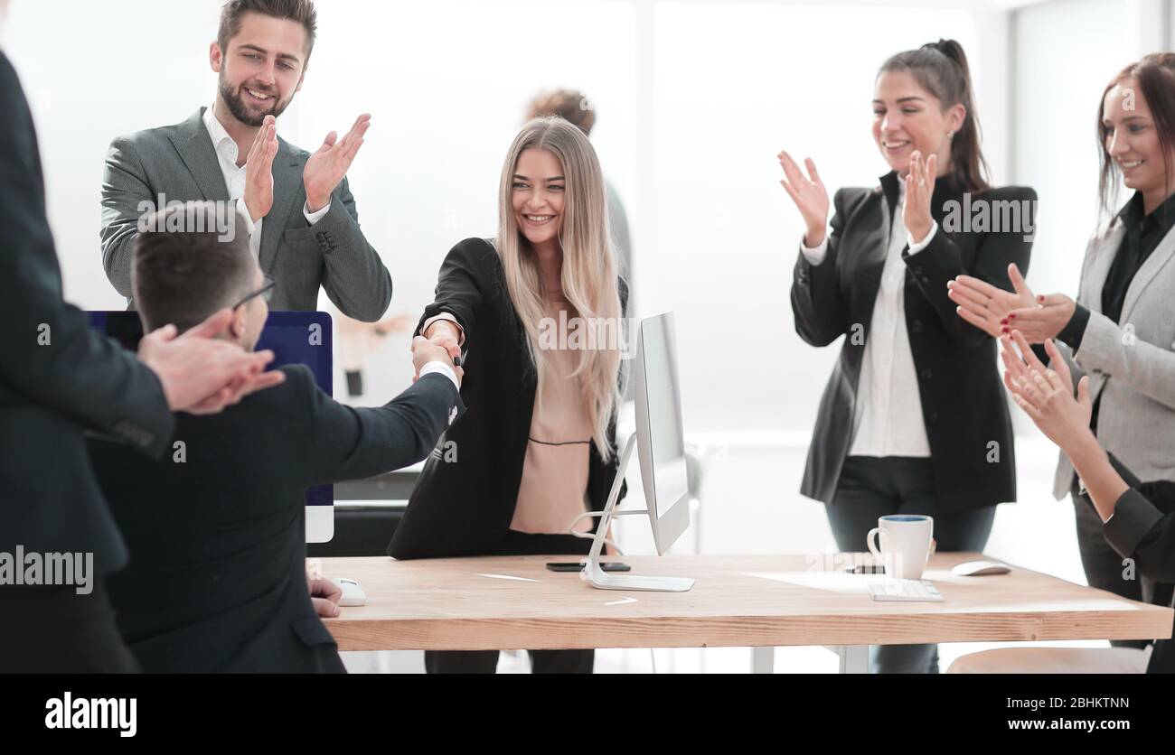 two young women shaking hands near an office Desk Stock Photo - Alamy