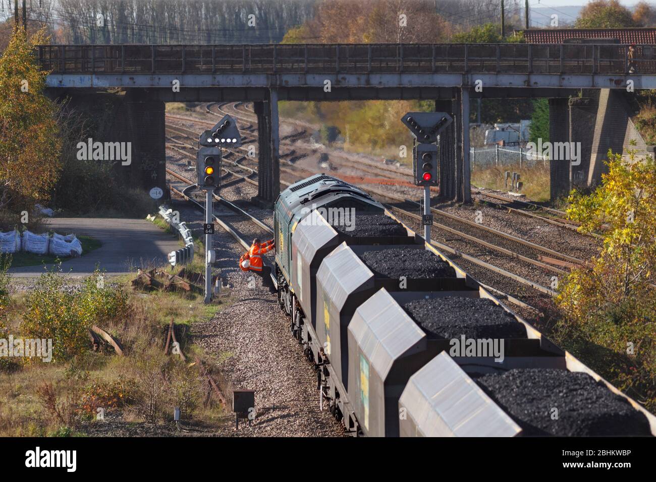 Freightliner driver climbing on board a class 66 locomotive hauling a ...