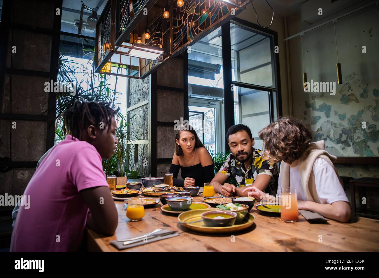 A group of friends spending time in a cafe Stock Photo - Alamy
