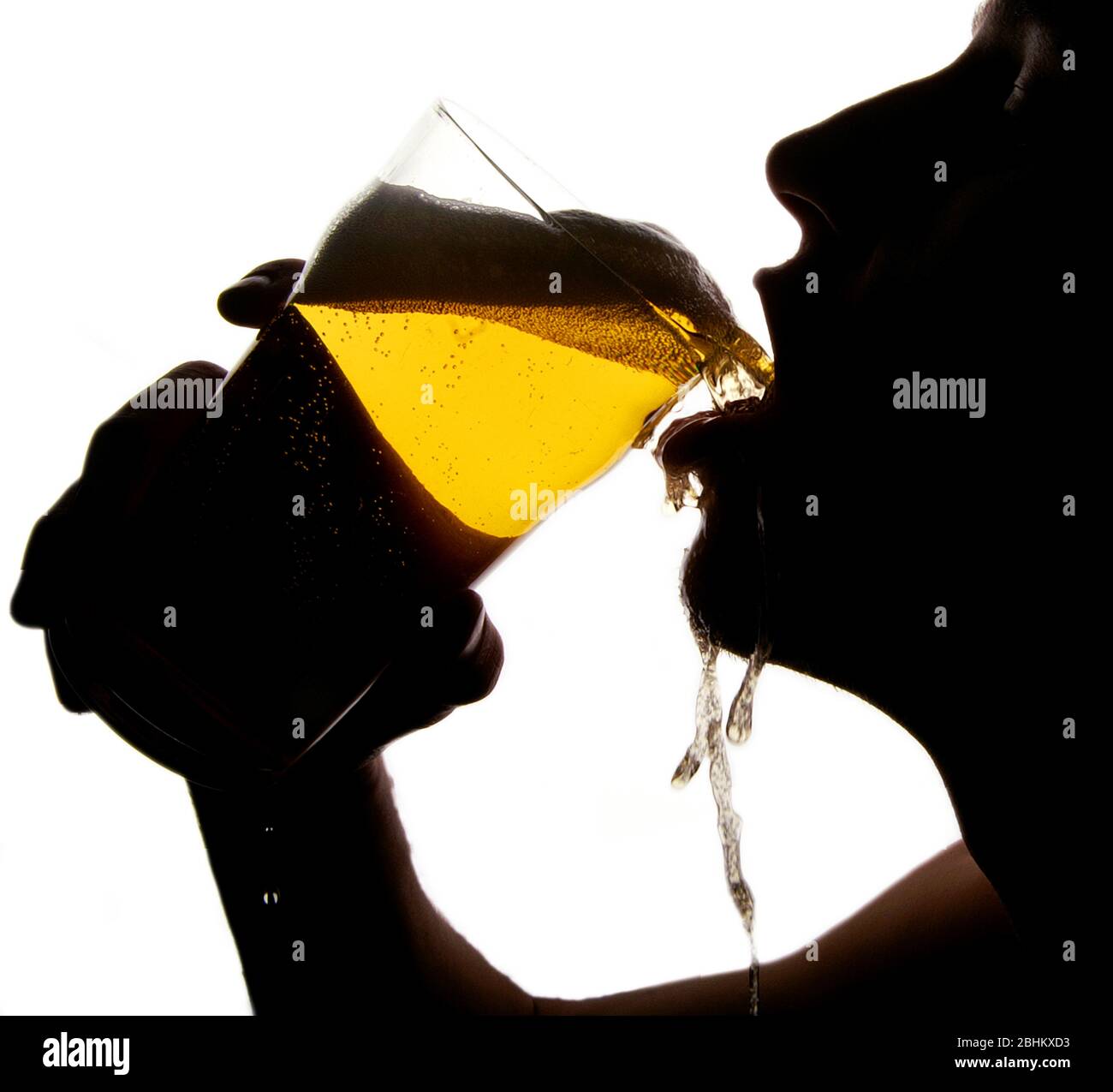 Side view of a man drinking alcahol. Alcohol is an addictive substance ...