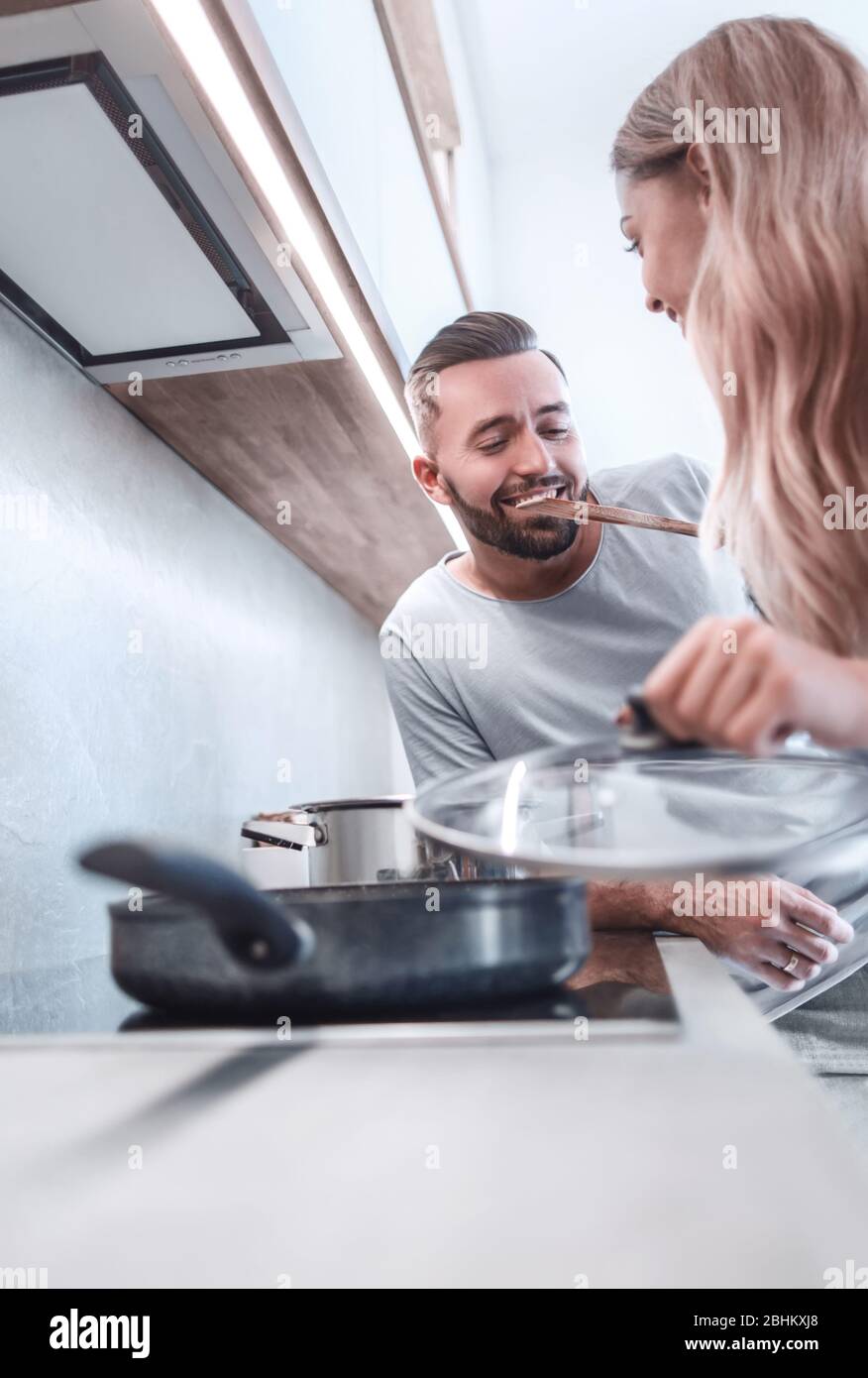 young husband and wife cook dinner together Stock Photo - Alamy
