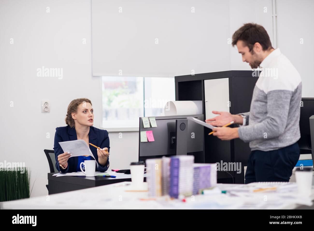 Business team of two people brainstorming in the office Stock Photo - Alamy