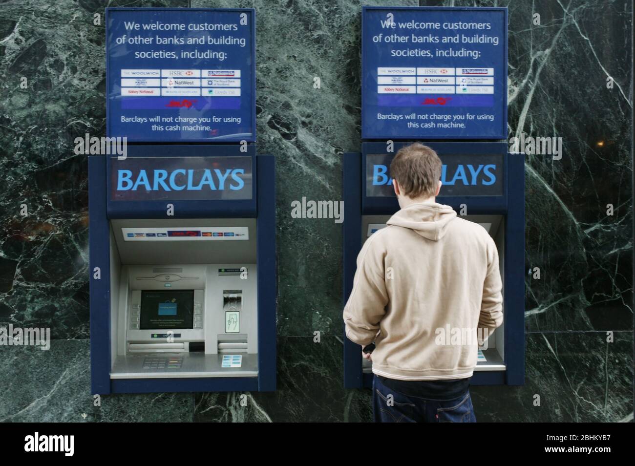 A man using a Barclays Bank cash machine Stock Photo - Alamy