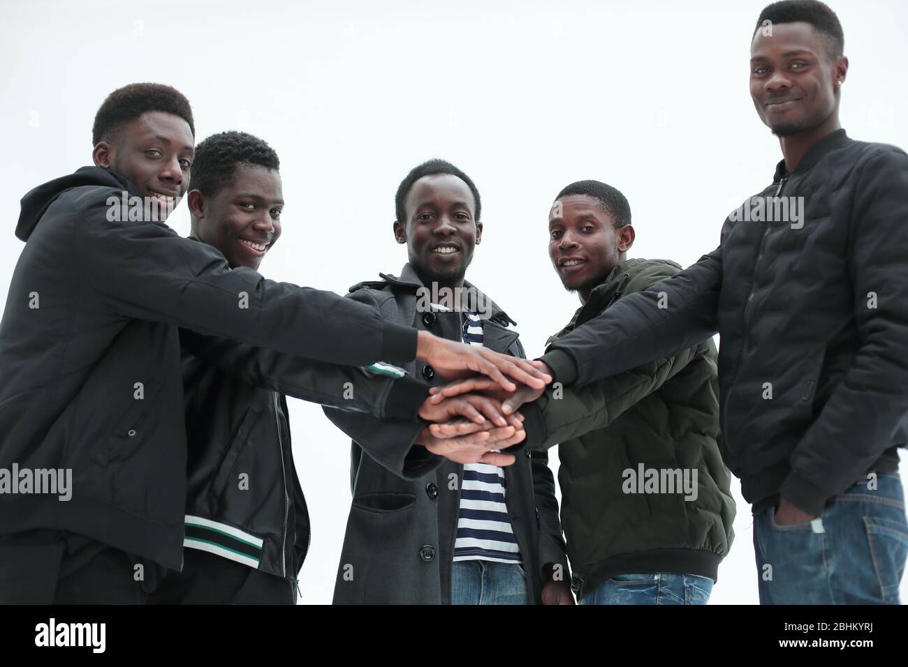 close up. group of guys putting their hands together Stock Photo - Alamy