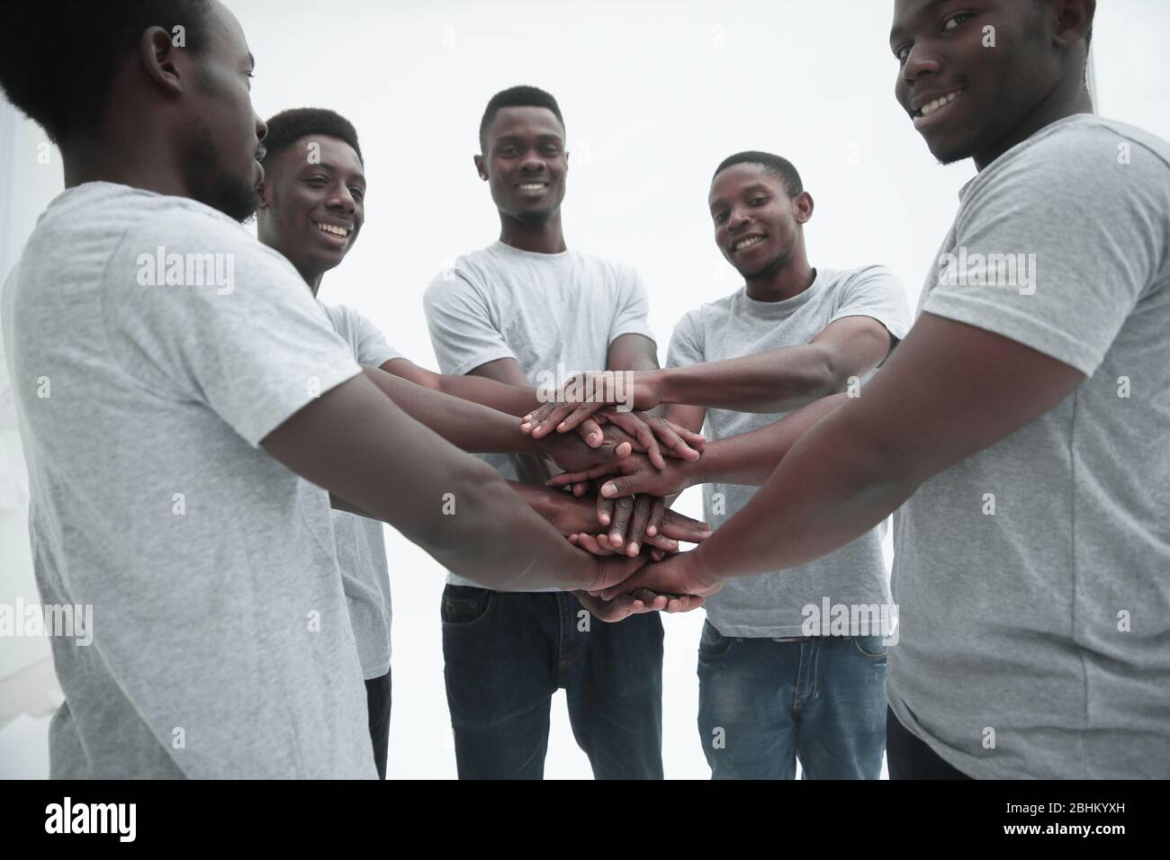 group of diverse guys making a tower out of hands Stock Photo - Alamy