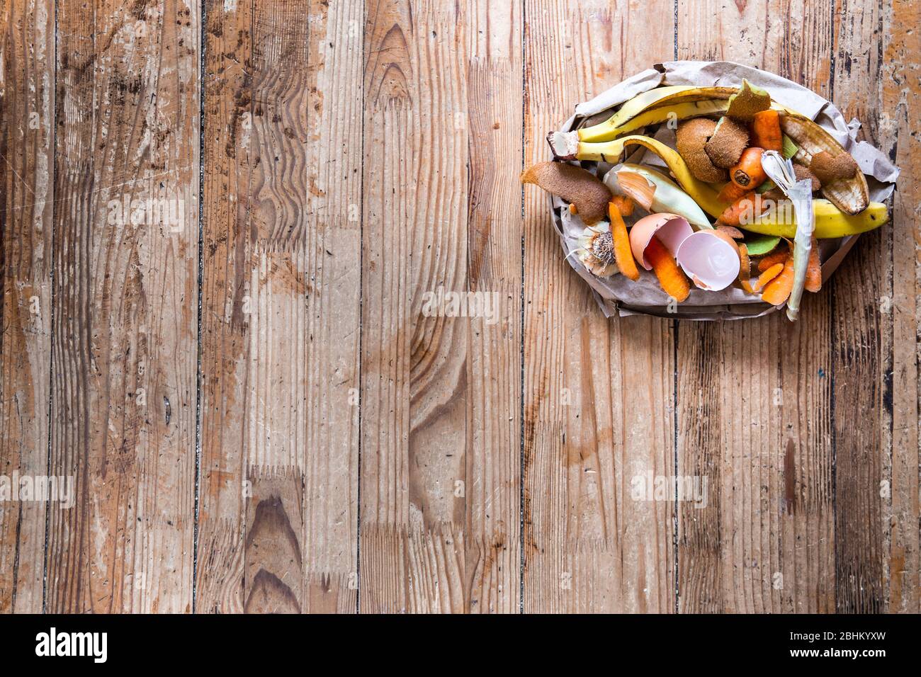 Organic food waste on a wooden background with space for text. Top view ...