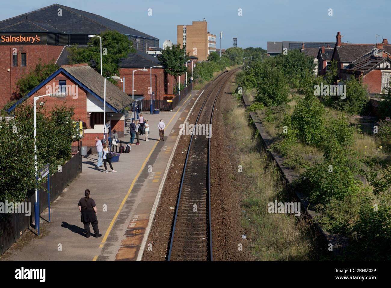 Northern Rail passengers at Saint Annes On Sea station on the single track south Fylde railway ...
