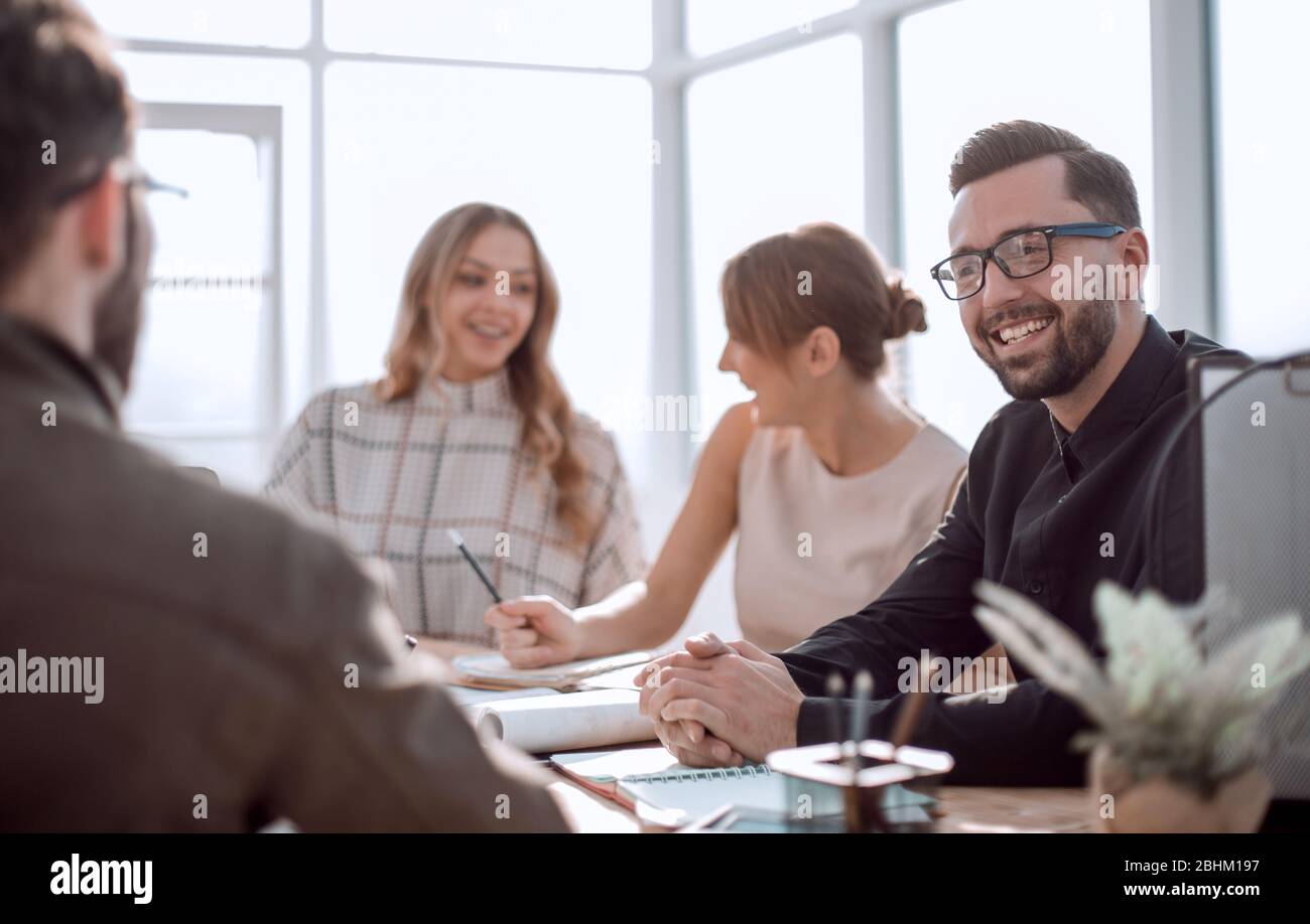 smiling businessman at a working meeting in the office Stock Photo - Alamy