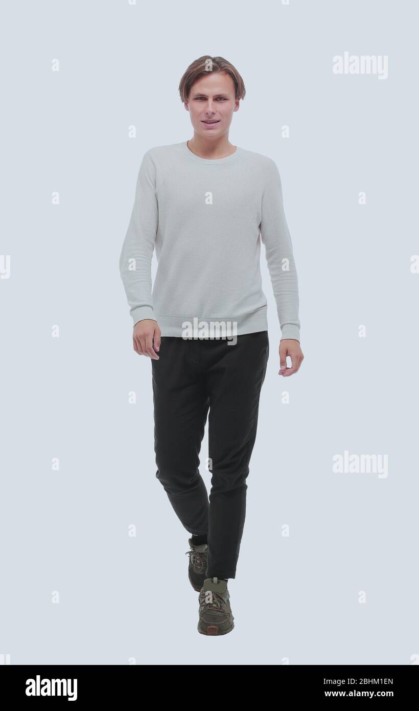 in full growth. confident young man striding forward Stock Photo - Alamy