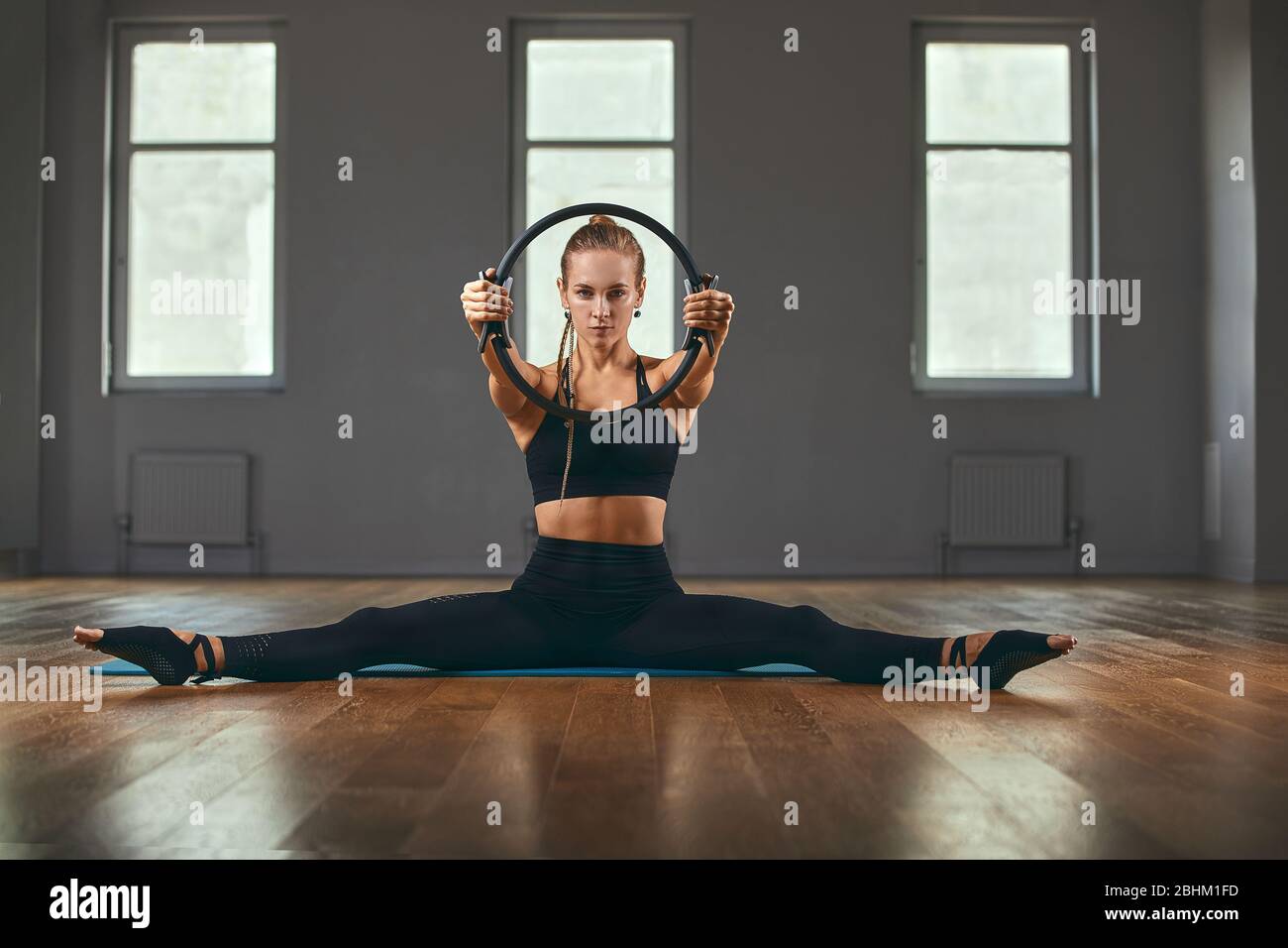 Fitness trainer with a beautiful figure poses for the camera during a ...