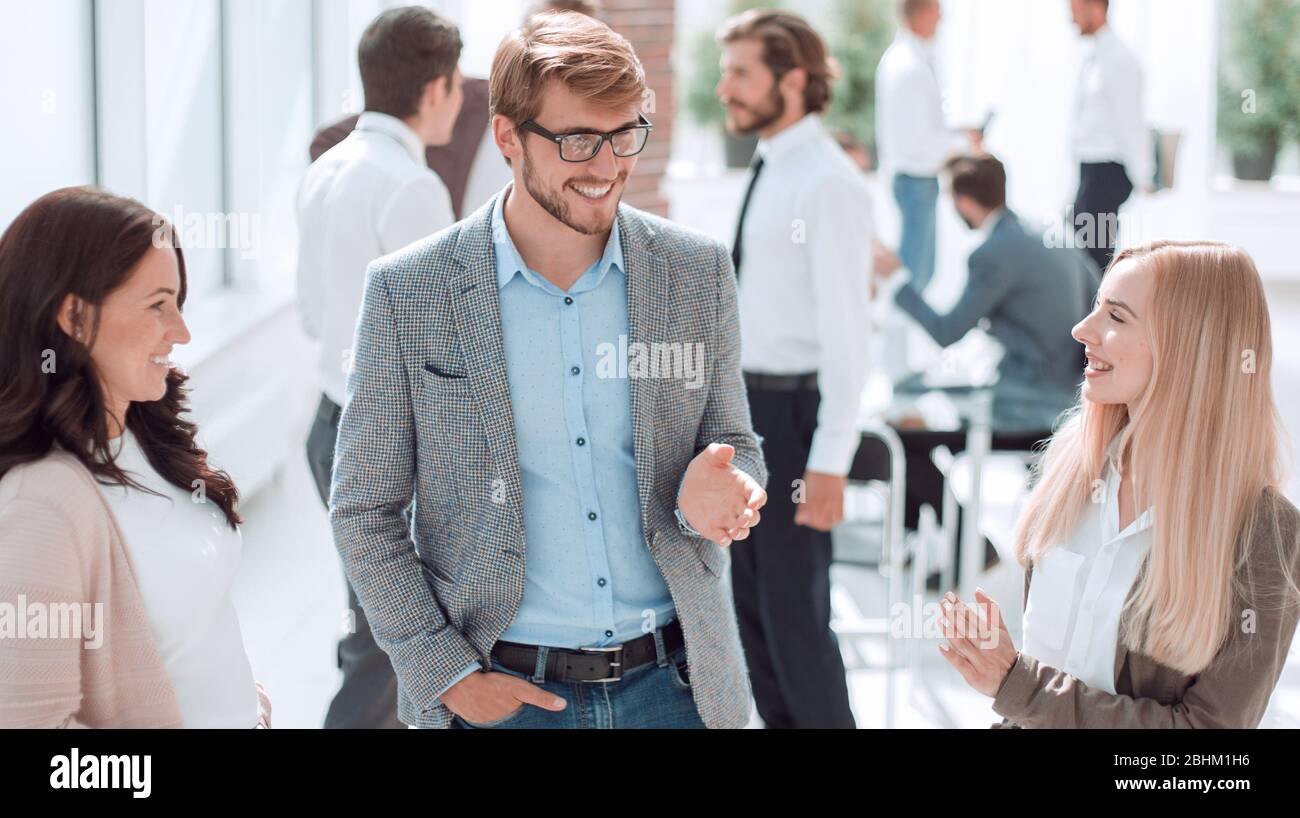 group of employees talking standing in the office Stock Photo - Alamy