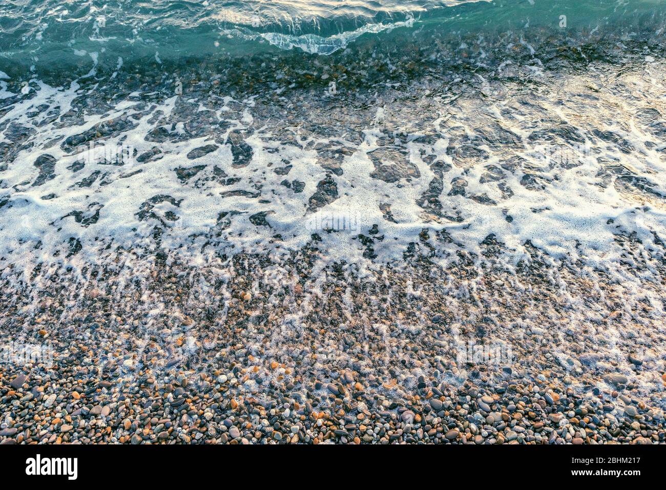 Small stones with sea wave on the beachю Stock Photo - Alamy