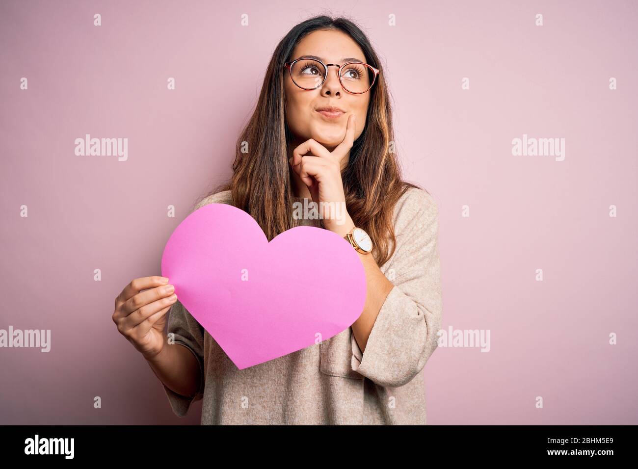 Young beautiful brunette romantic woman holding big heart paper ...