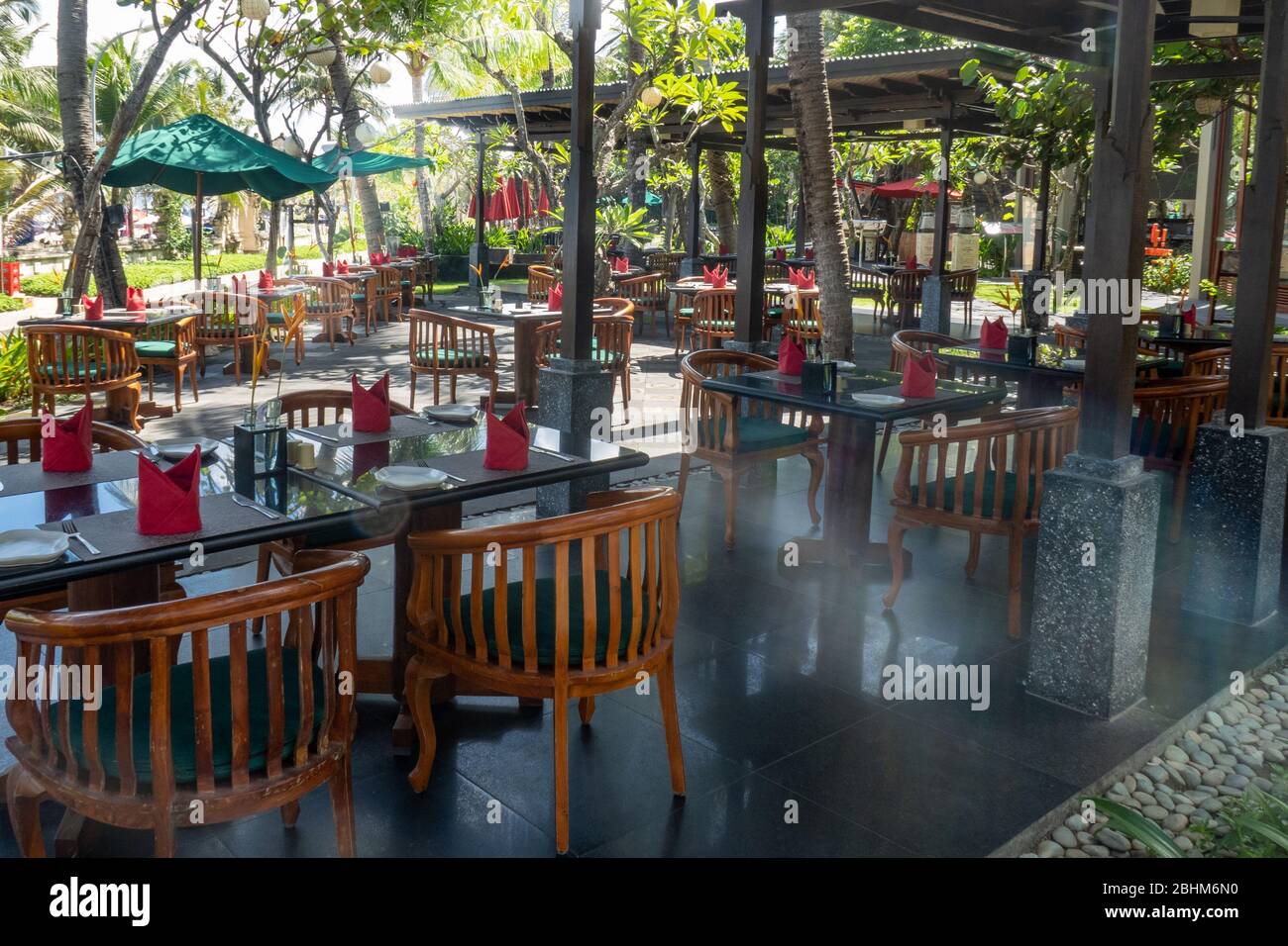 Tables and chairs set in the empty outdoor restaurant in tropical ...
