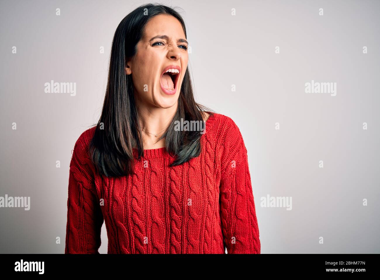 Young brunette woman with blue eyes wearing casual sweater over ...