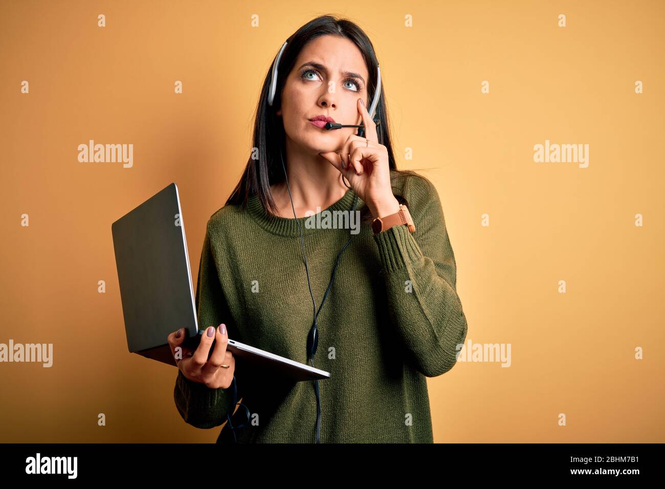 Young operator woman with blue eyes working on call center using ...