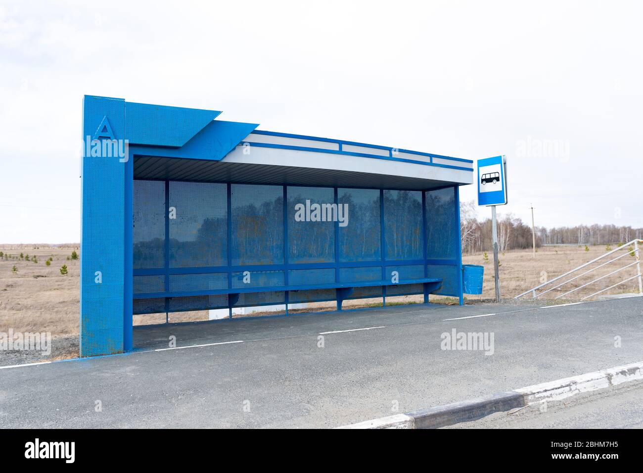 Empty bus stop. Modern steel roadside bus stop with seat Stock Photo ...