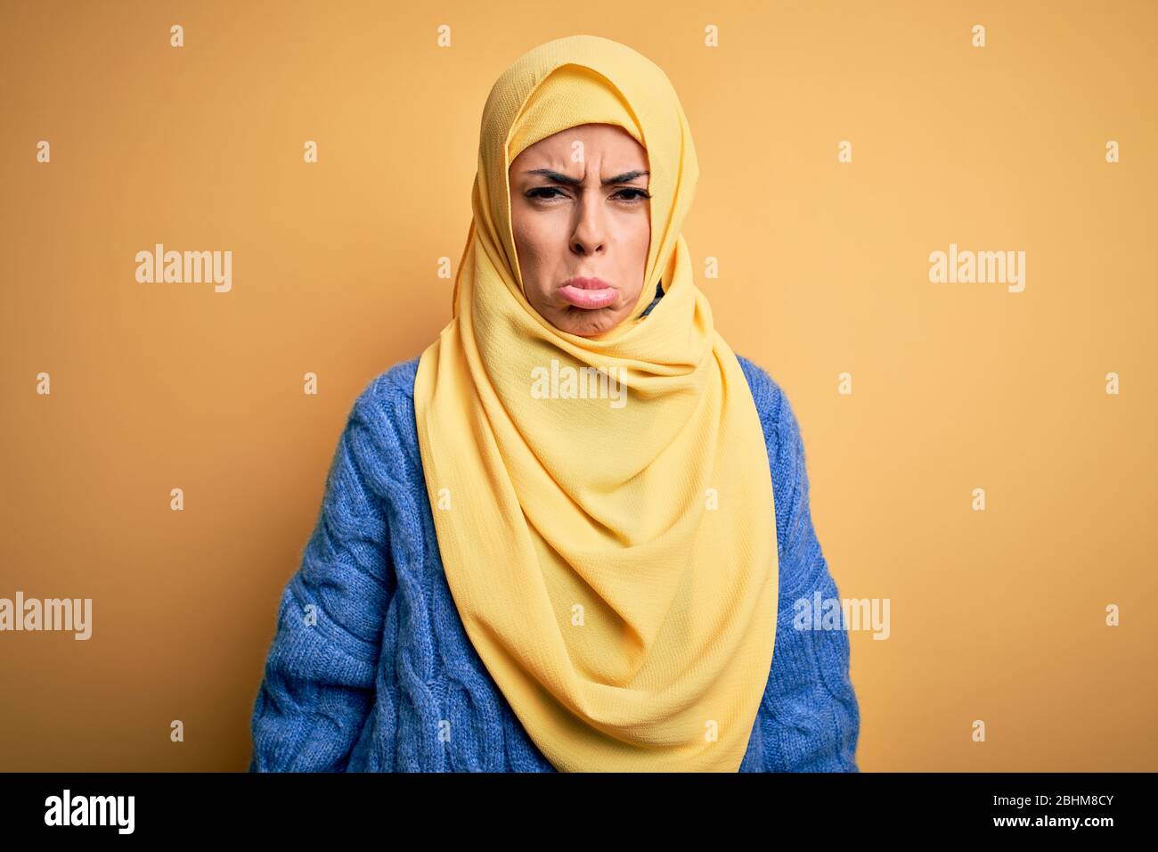 Young beautiful brunette muslim woman wearing arab hijab over isolated ...