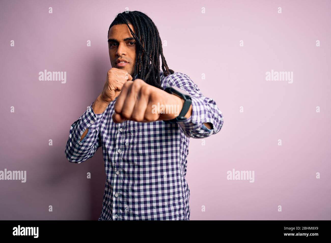 Young handsome african american afro man with dreadlocks wearing casual ...
