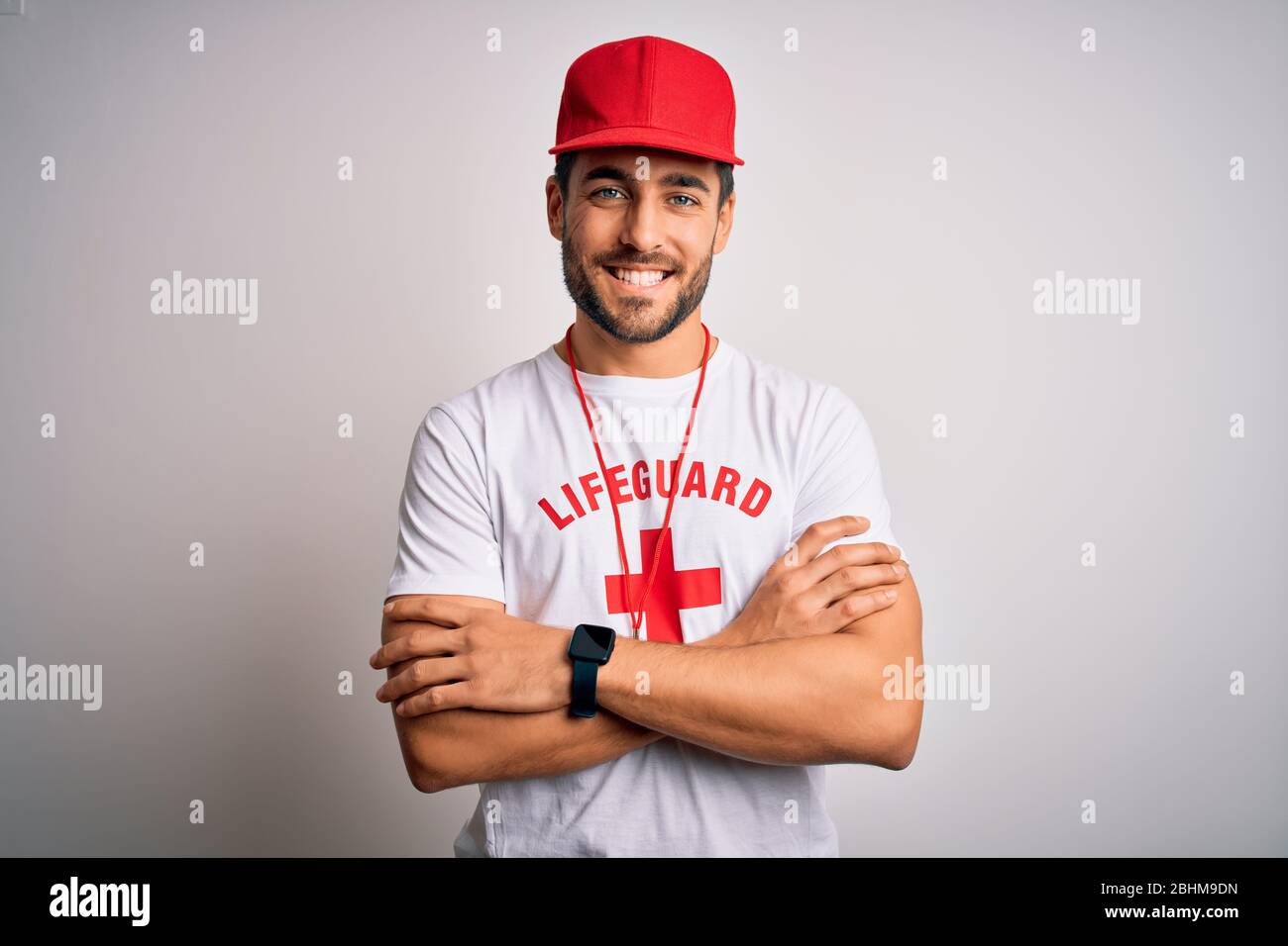 Young handsome lifeguard man with beard wearing t-shirt with red cross ...