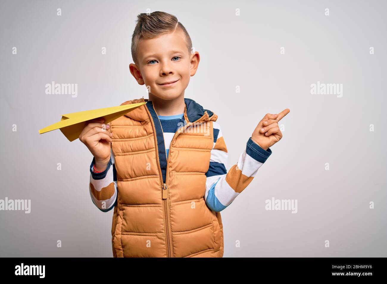 Young little caucasian kid having fun and playing imagination fly with ...