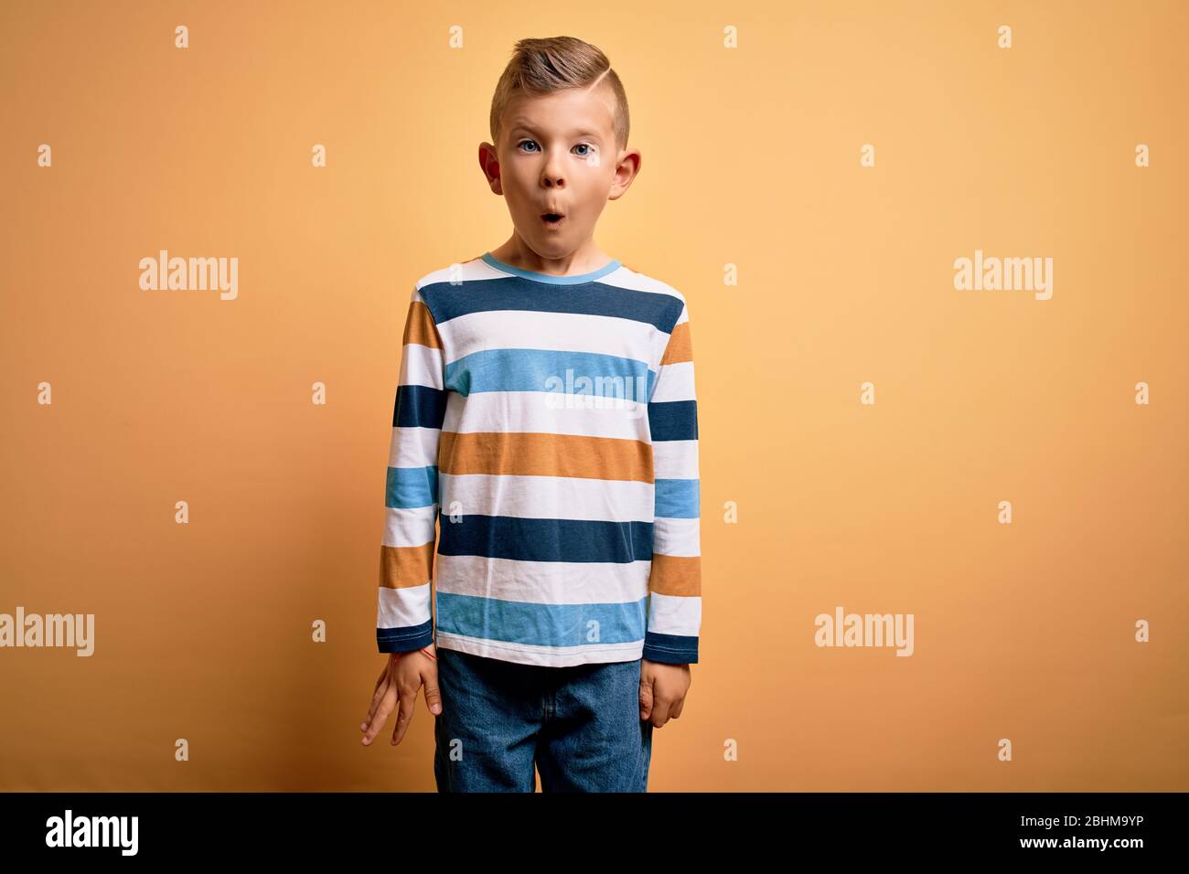 Young little caucasian kid with blue eyes wearing colorful striped ...