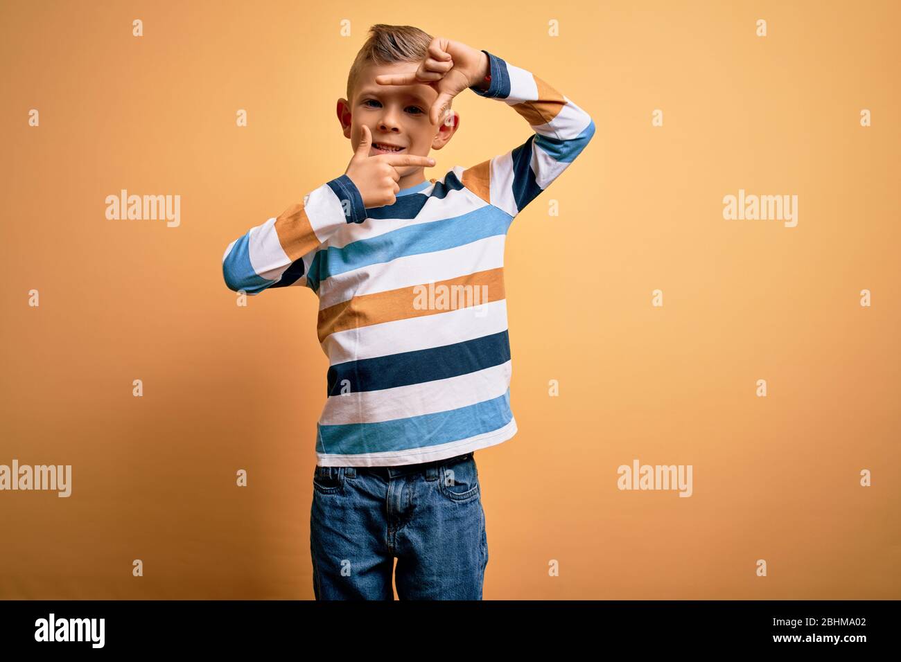 Young little caucasian kid with blue eyes wearing colorful striped ...