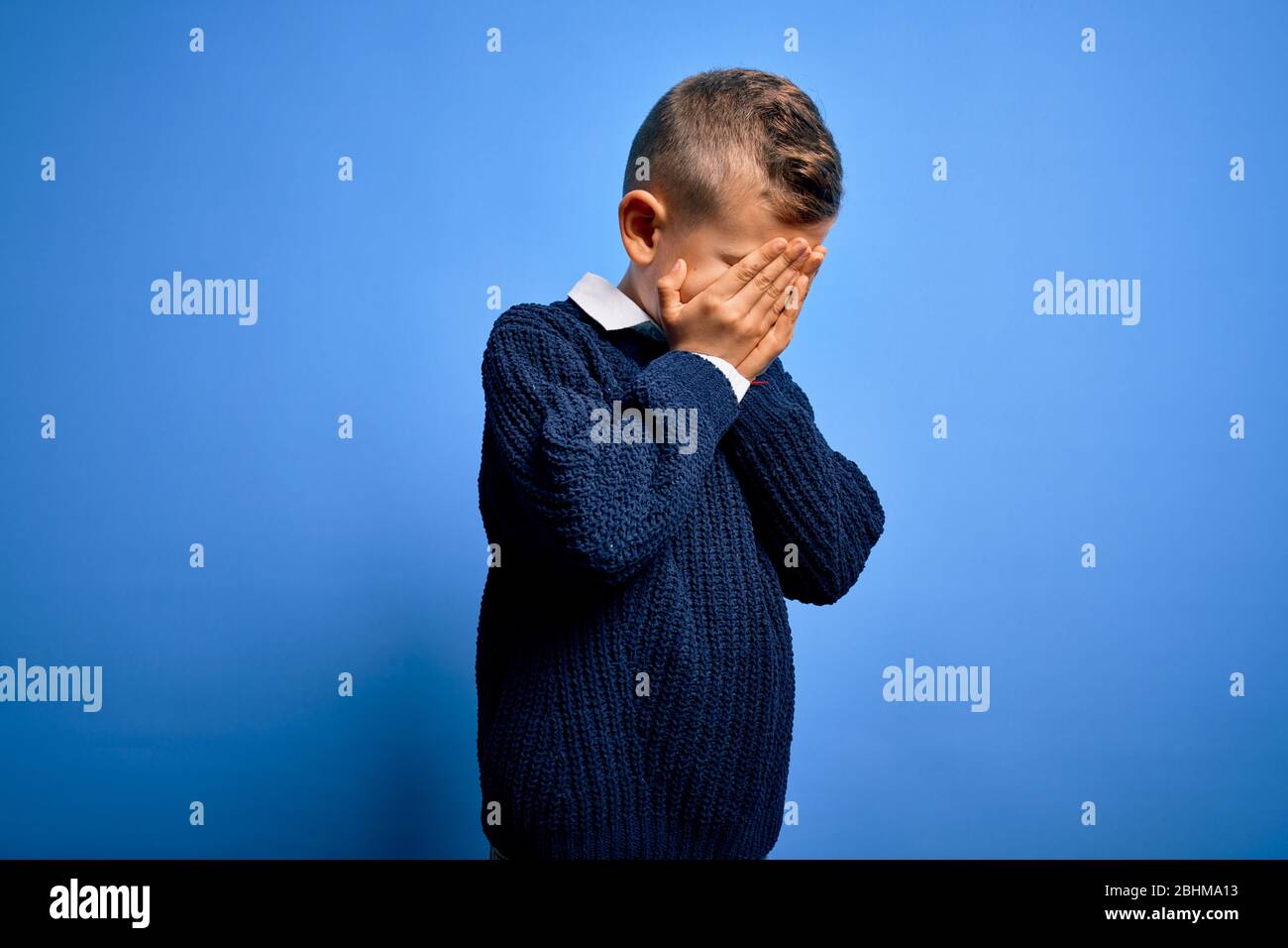 Young little caucasian kid with blue eyes wearing winter sweater over ...
