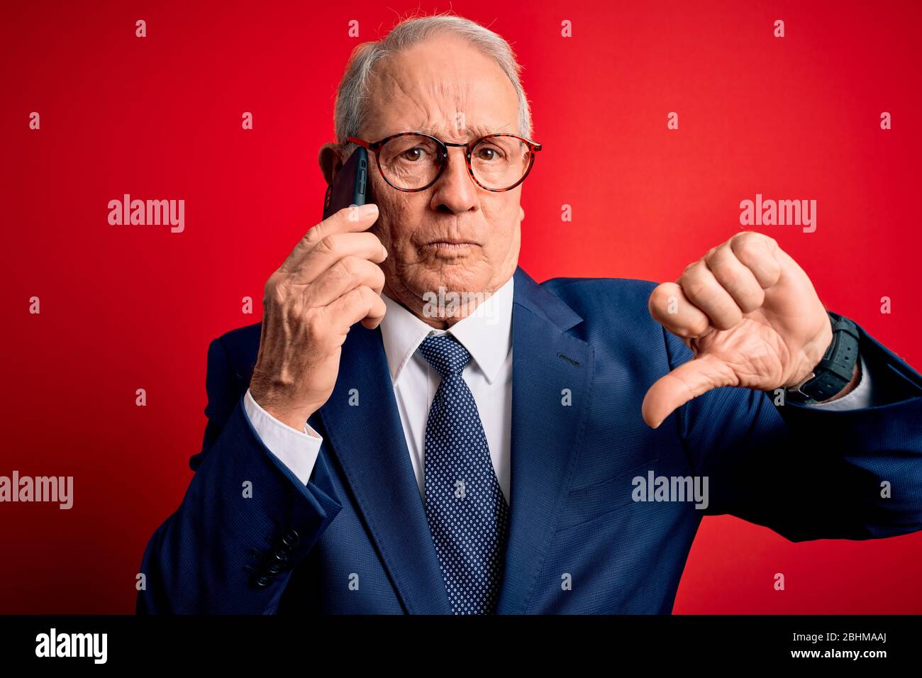 Grey haired senior business man having a conversation talking on ...