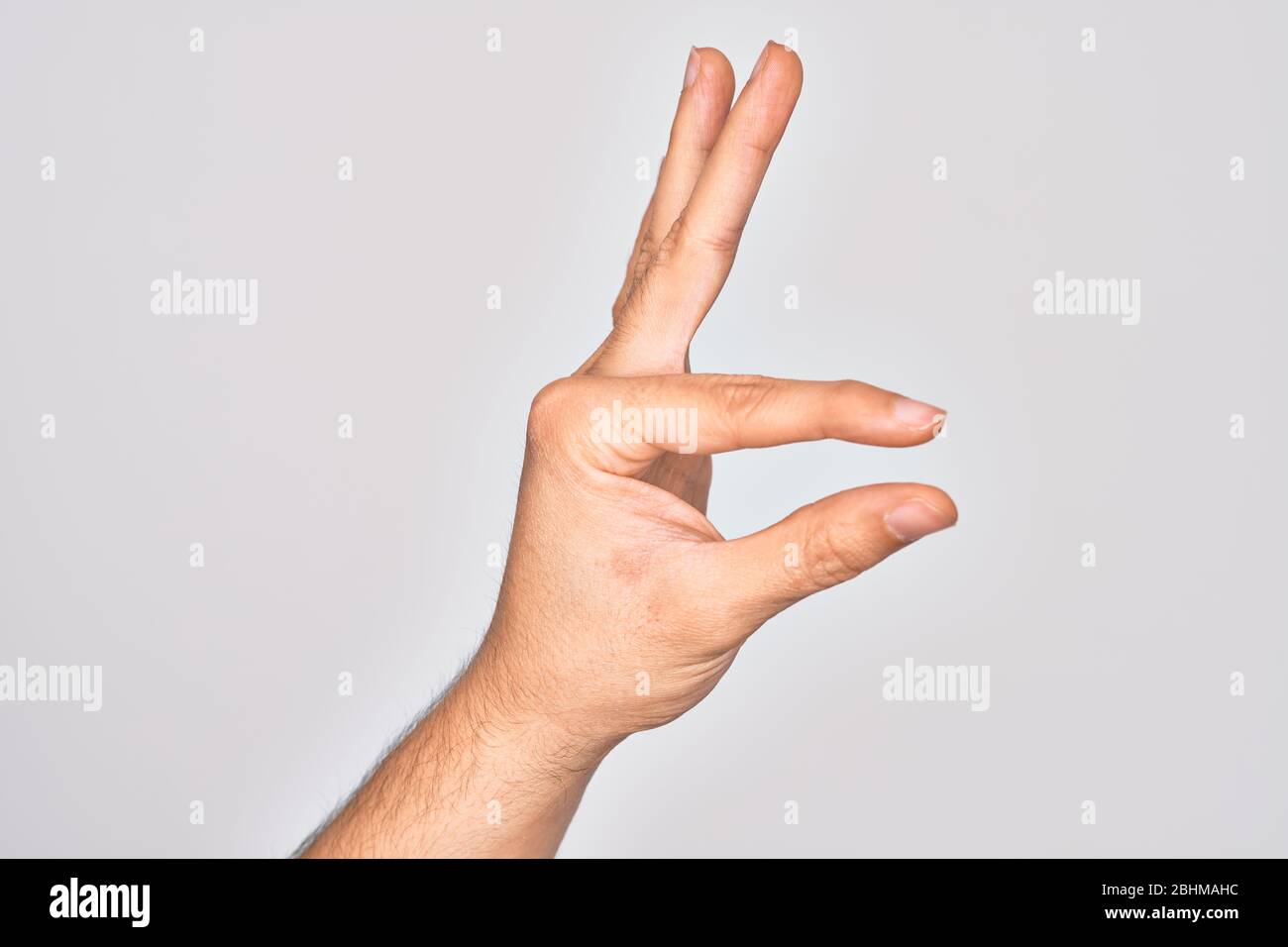 Hand of caucasian young man showing fingers over isolated white background picking and taking ...