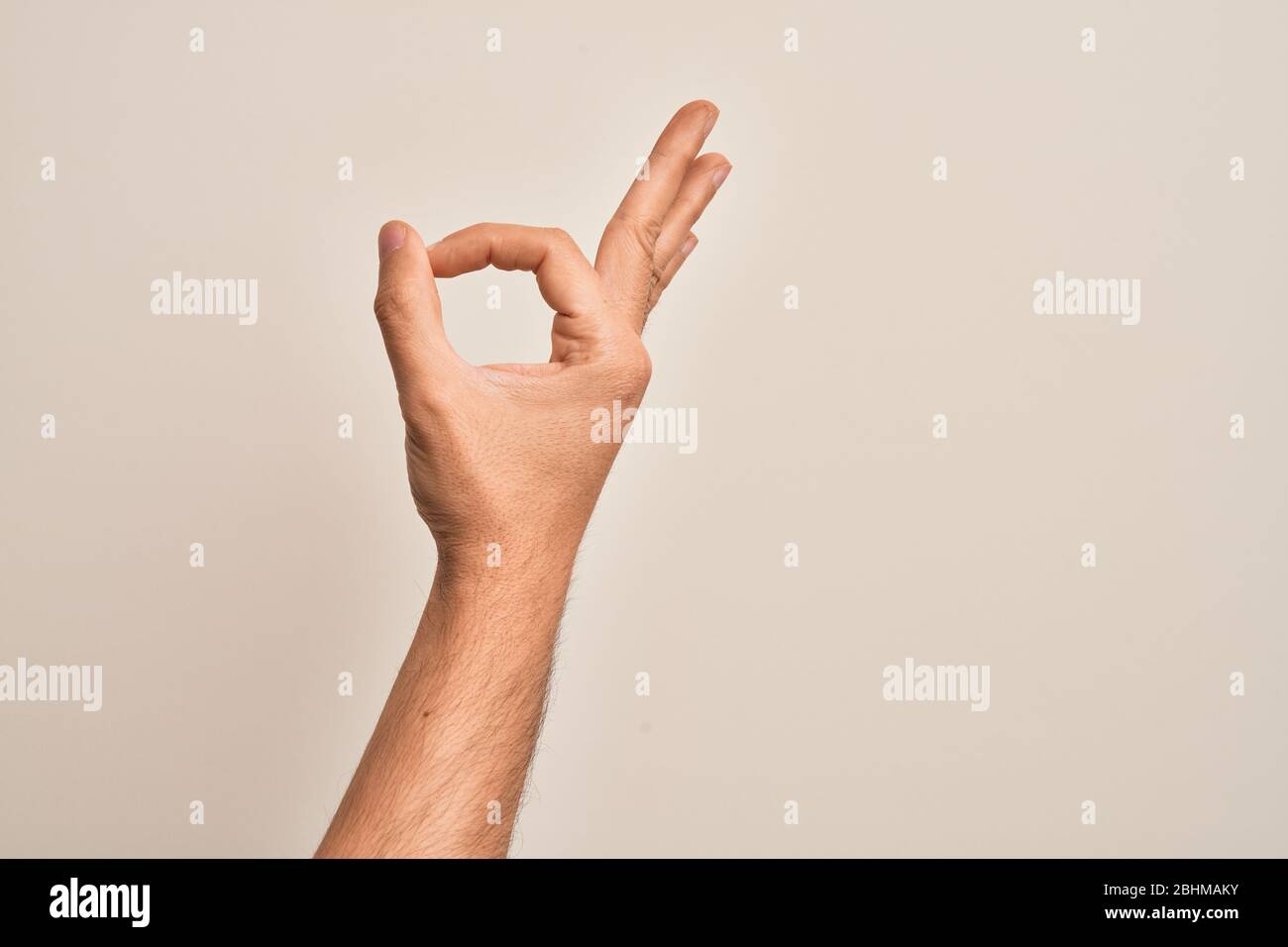Hand of caucasian young man showing fingers over isolated white ...