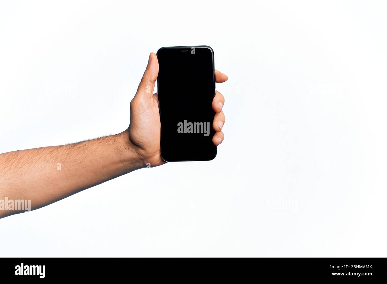 Hand of caucasian young man holding smartphone showing screen over ...