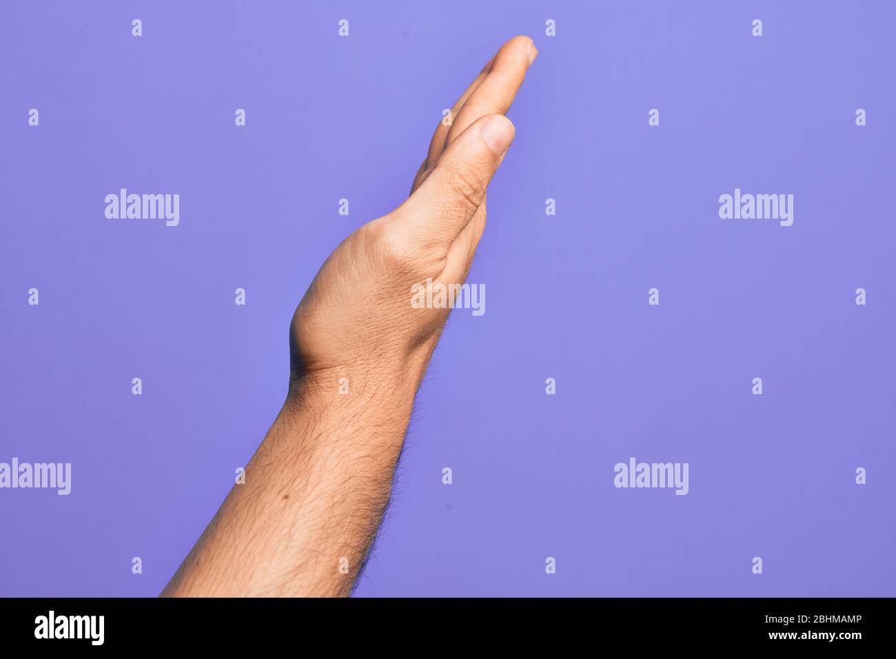 Hand of caucasian young man showing fingers over isolated purple ...