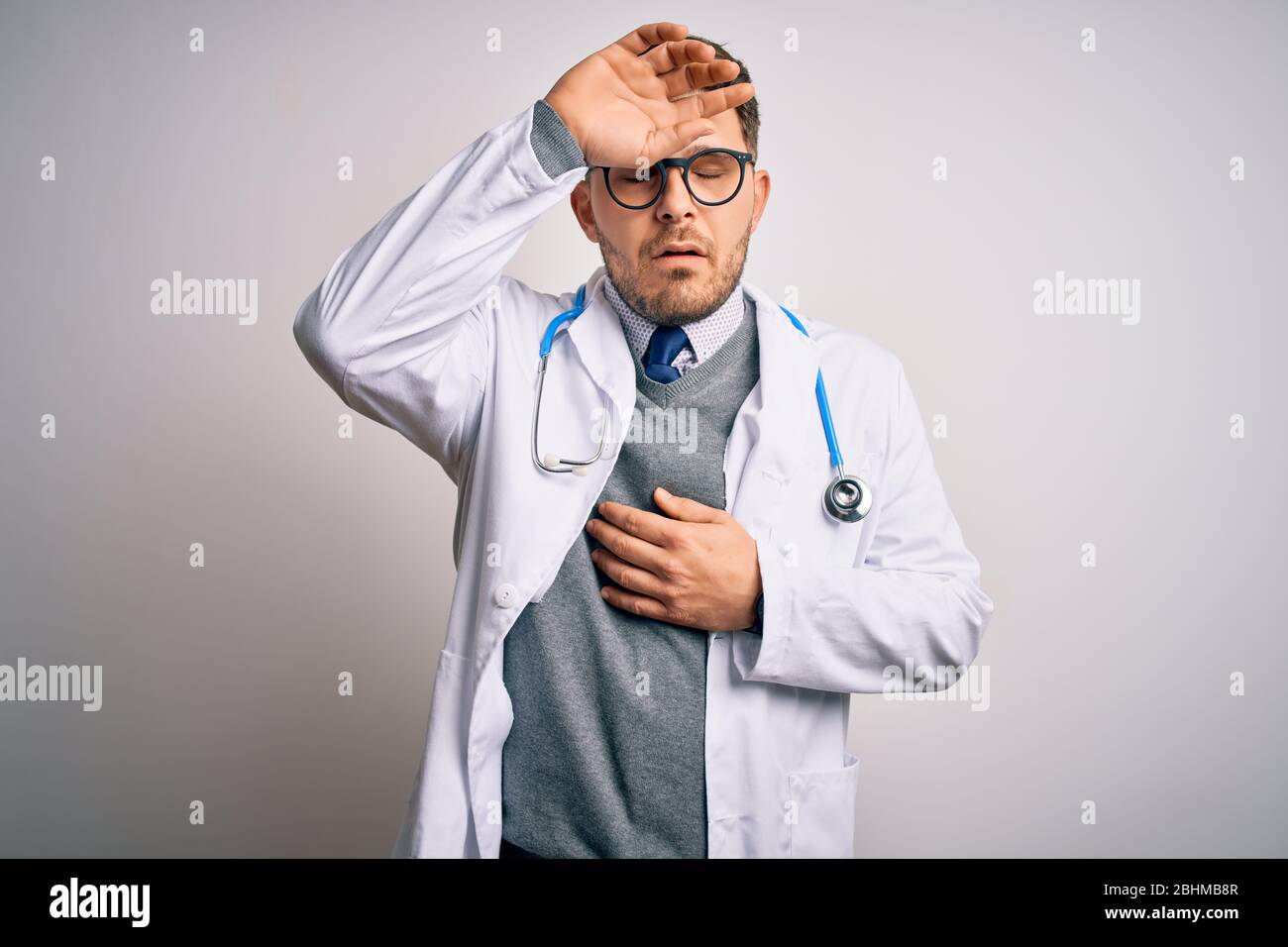 Young doctor man with blue eyes wearing medical coat and stethoscope ...