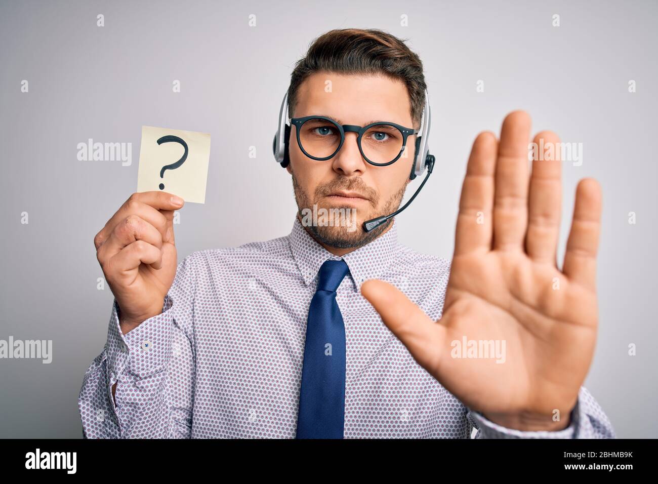 Young call center operator business man with blue eyes holding paper ...