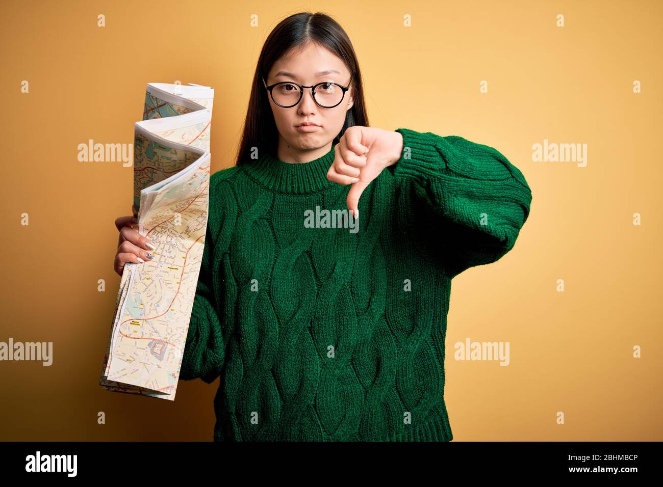 Young asian turist woman looking at city tourist map on a trip over ...