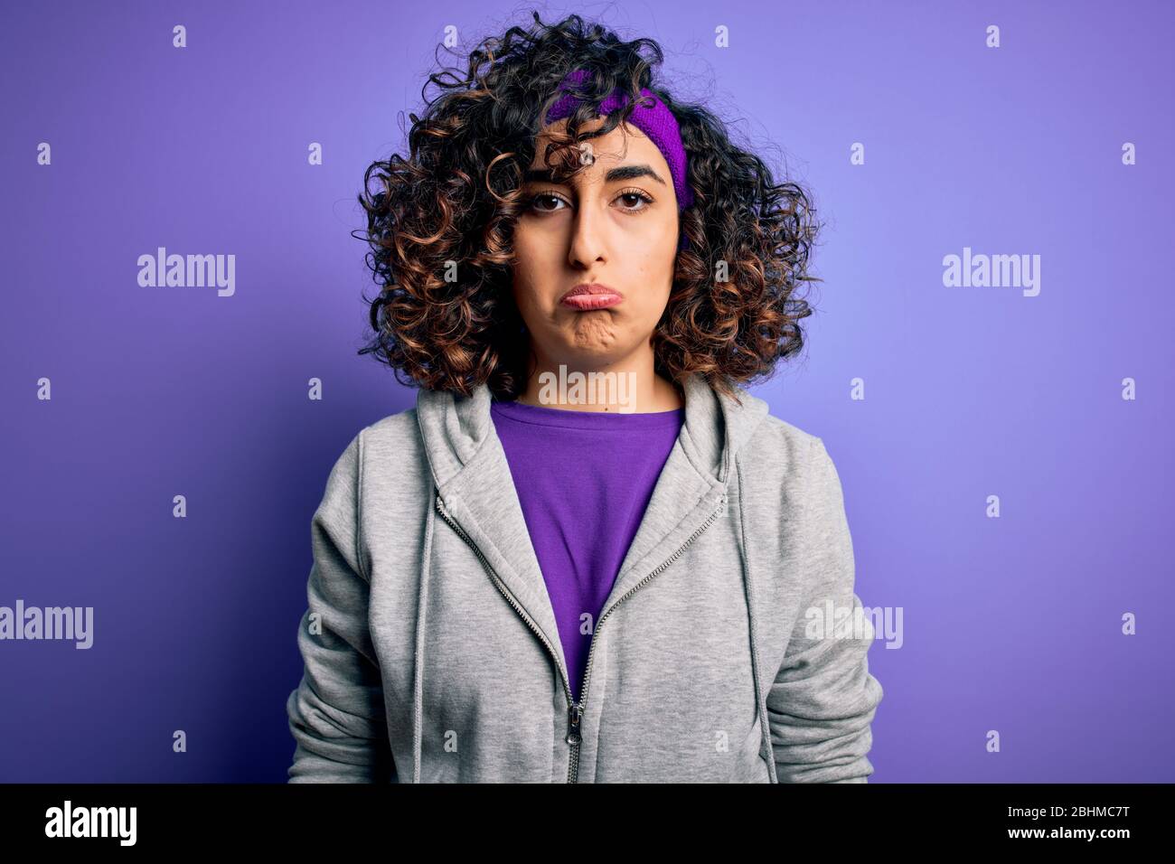 Beautiful curly arab sportswoman doing sport wearing sportswear over ...