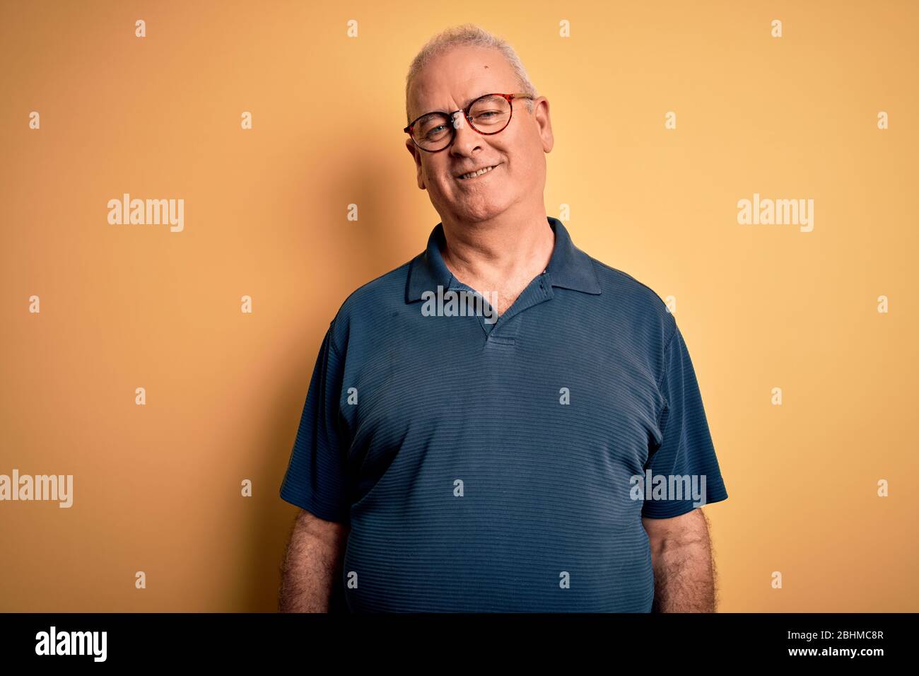 Middle age handsome hoary man wearing casual polo and glasses over ...
